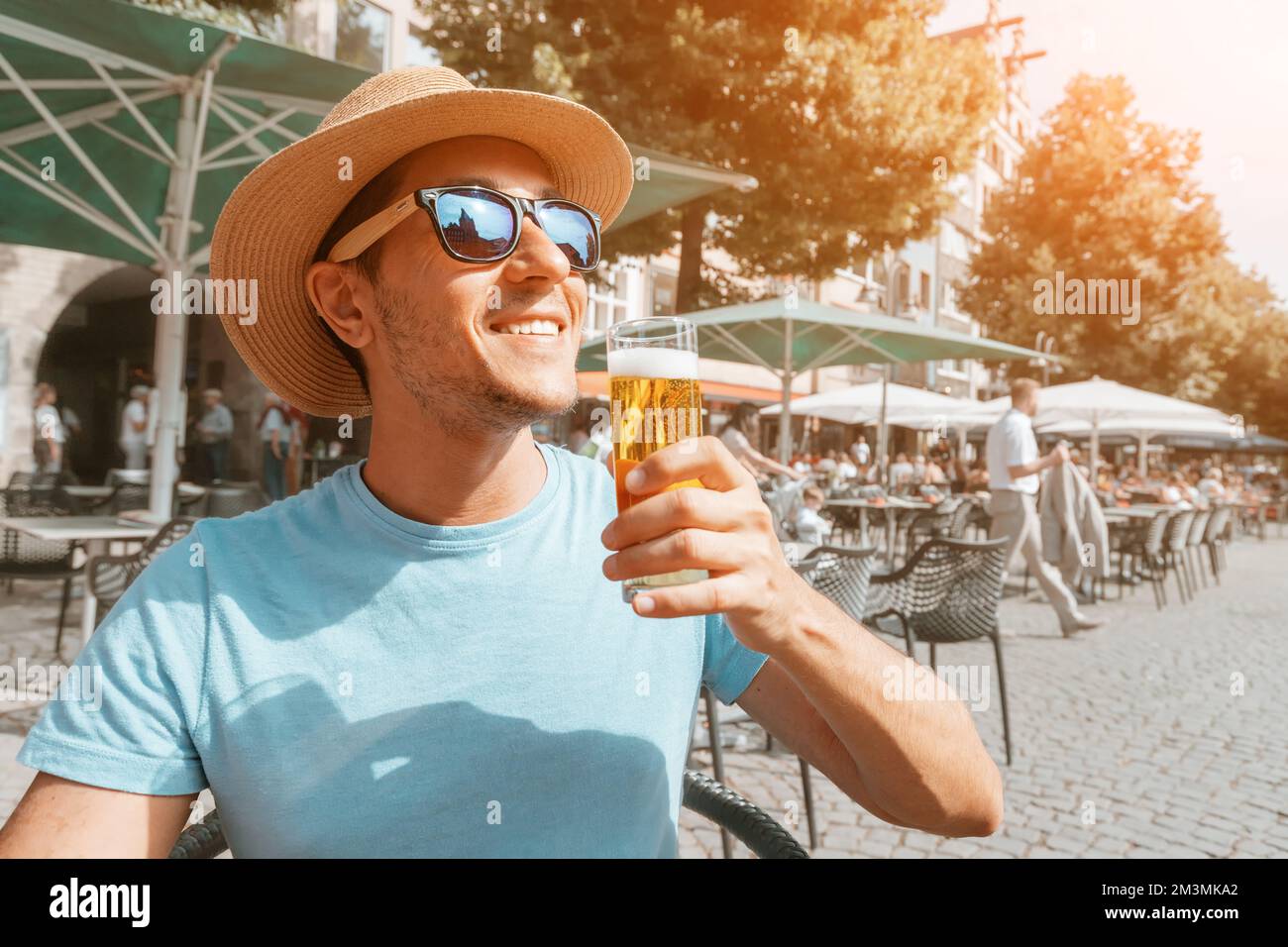 Tourist happy man wearing sunglasses and hat tasting and drinking ...