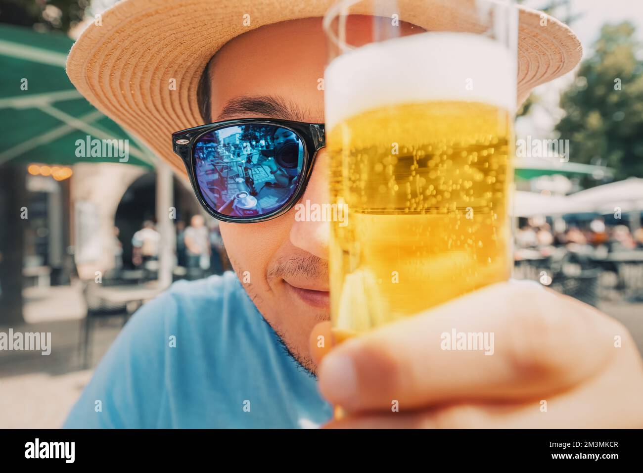 Tourist happy man wearing sunglasses and hat tasting and drinking ...