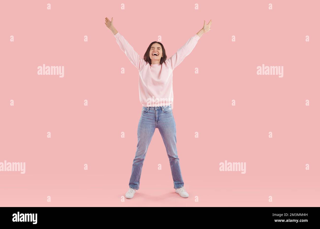 Happy laughing girl with raised hands and open palms up Stock Photo - Alamy