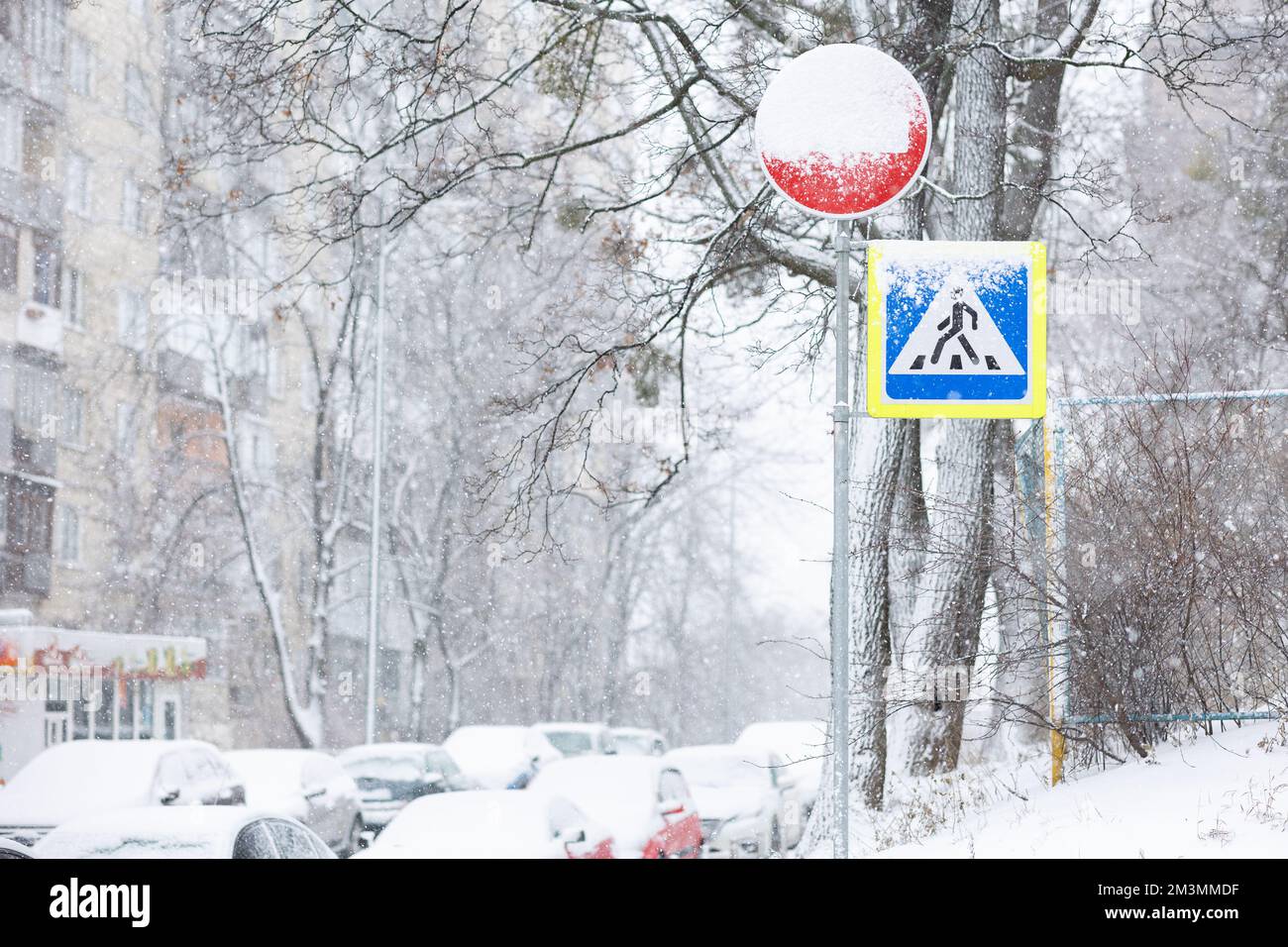 difficult road conditions - road in the winter snowfall with pedestrian ...