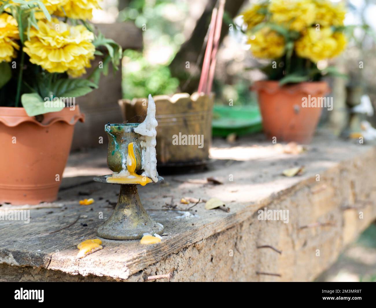 buddhist candle holder with candles flowing down Stock Photo - Alamy