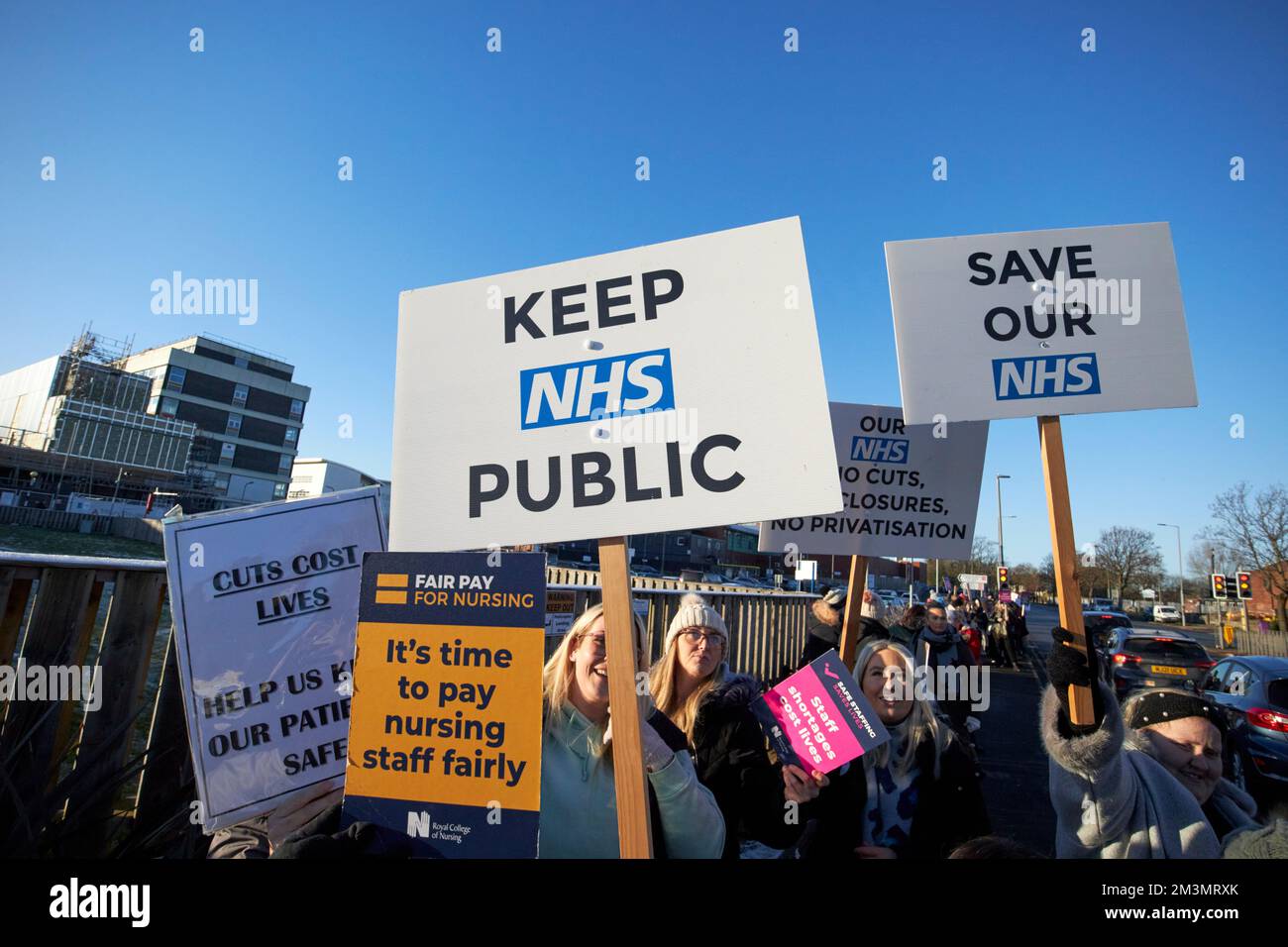 Nurses Holding Up Placards On The Picket Line During Strike Day Outside
