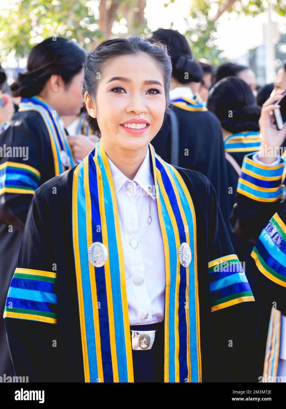 The graduate wore a gown from a university in Thailand. For graduation ...