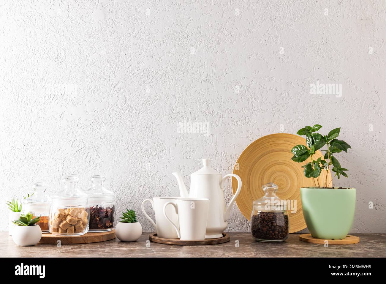 the kitchen background of a modern countertop. coffee pot with mugs ...