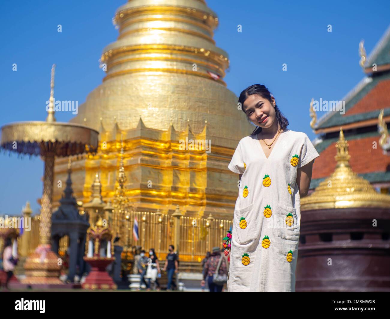 A woman standing inside a temple with a pagoda behind Stock Photo - Alamy