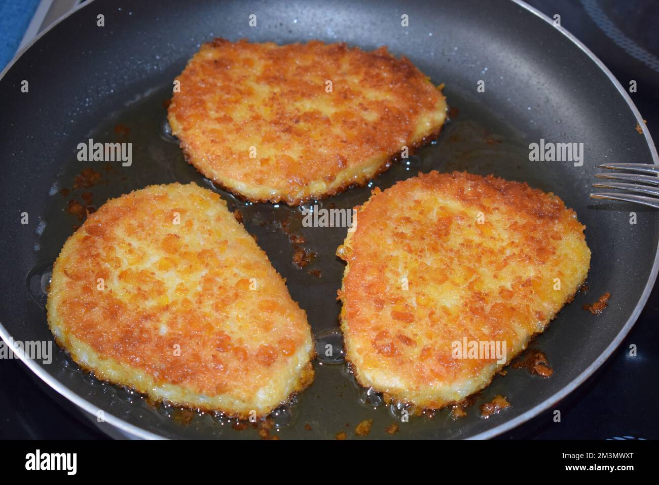 roasting breaded chicken Stock Photo - Alamy