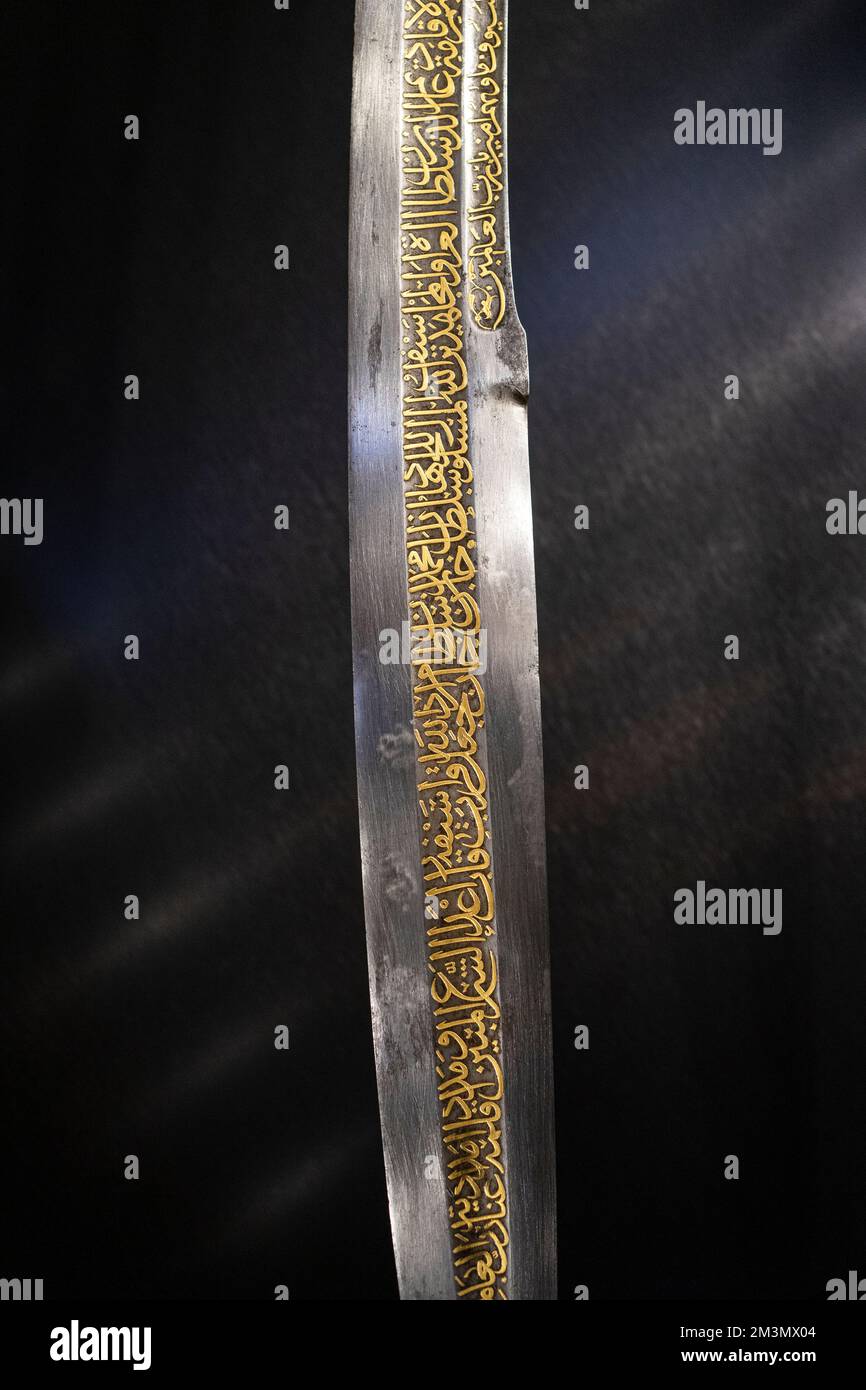 A closeup of a sword surface with Arabic calligraphy isolated on a ...