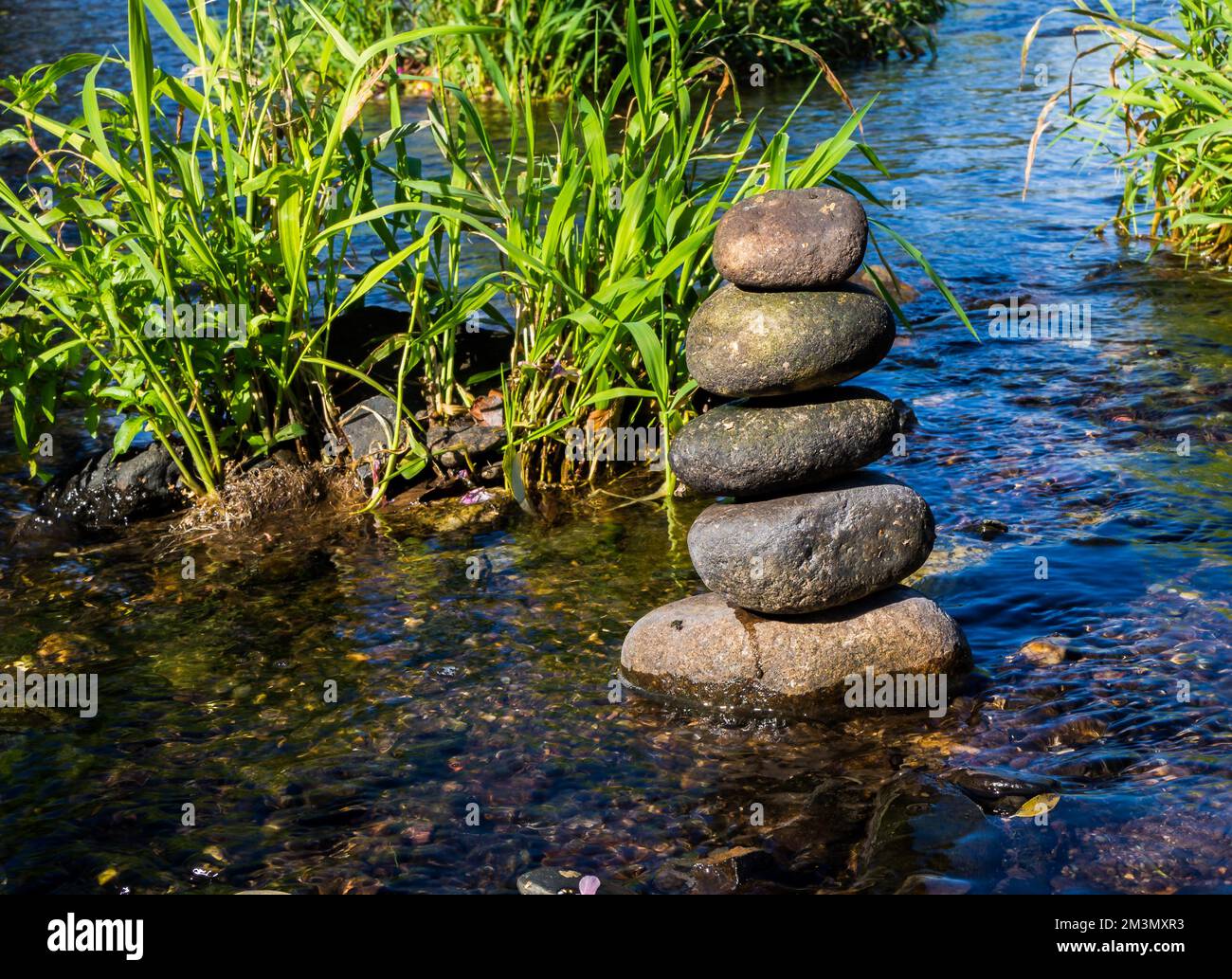 Balance stone in a river 02 Stock Photo - Alamy