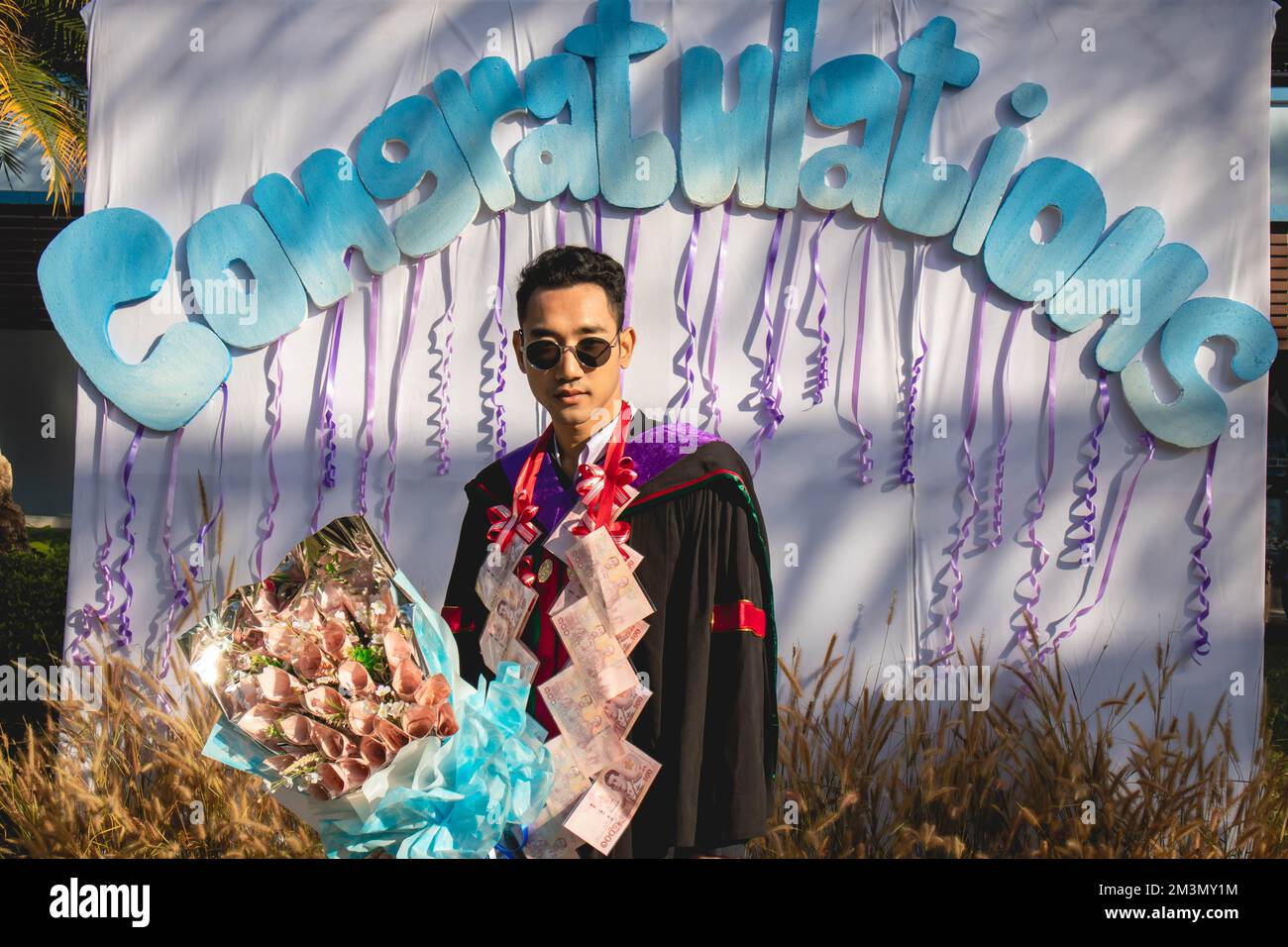 The graduate wore a gown from a university in Thailand. For graduation ...