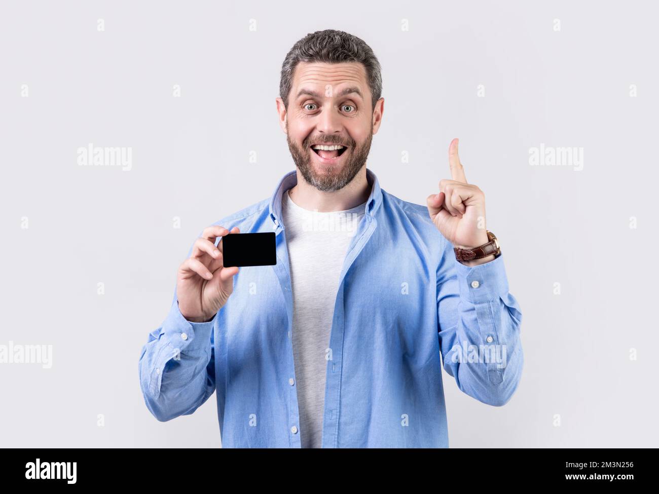 amazed man with business debit in studio. man holding business debit ...