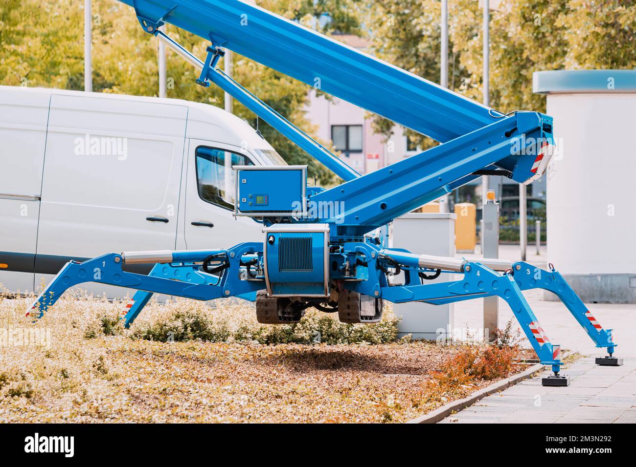 Industrial telescopic unmanned crane standing on hydraulic support legs ...