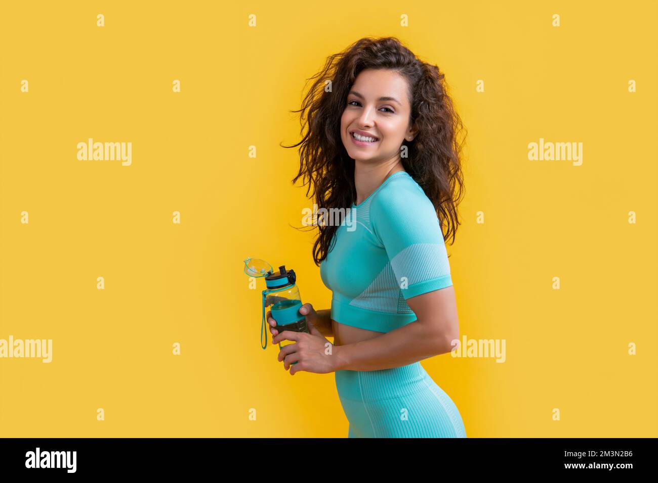 glad fitness woman with sport water bottle in studio. fitness woman ...