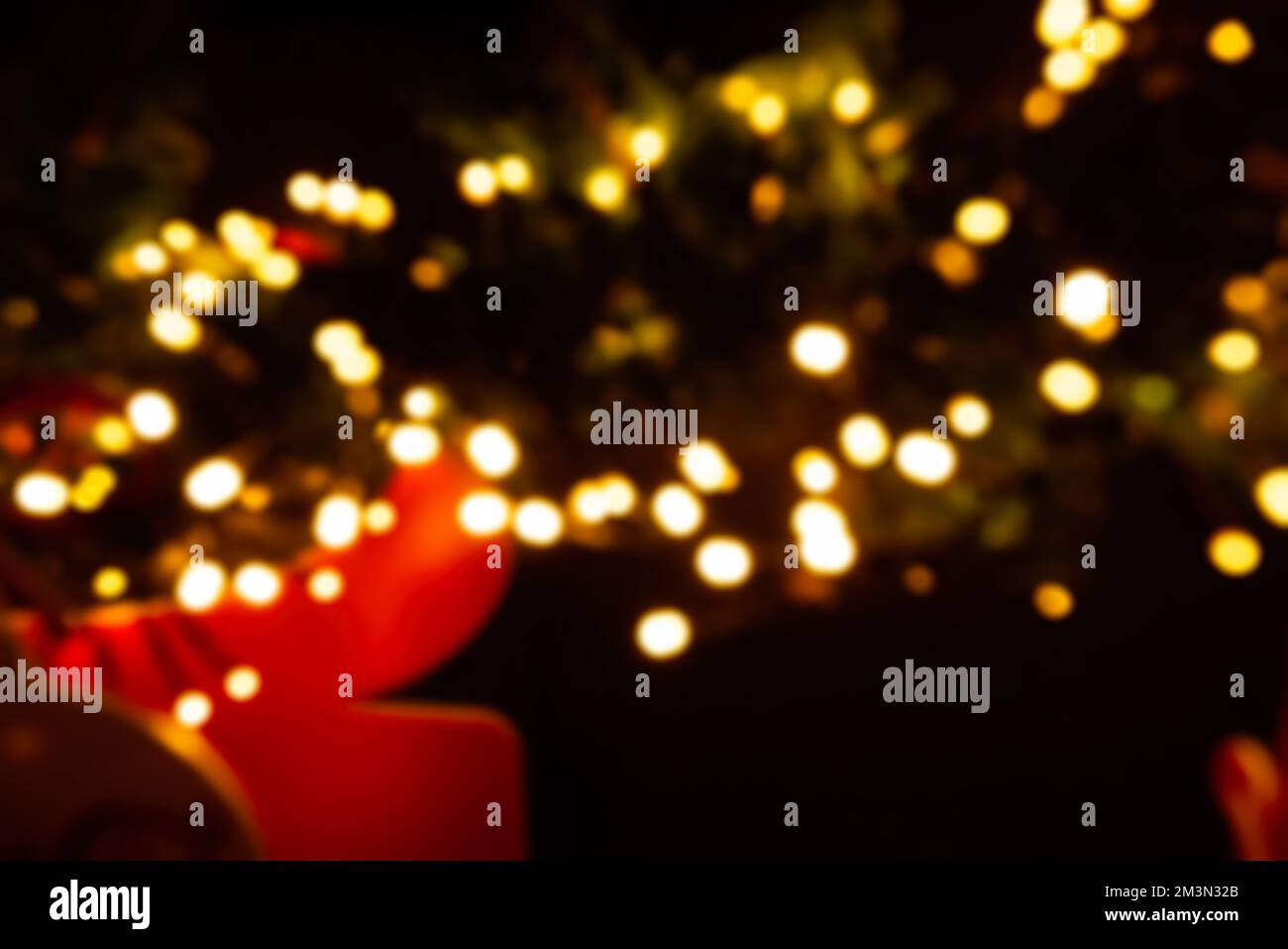 Bright, blurry lights on a Christmas tree from a garland. Festive ...