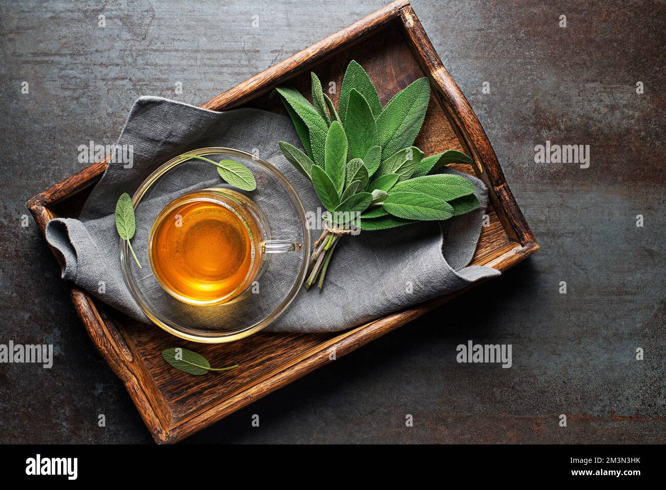 Sage tea in a cup served on a trey close up Stock Photo - Alamy