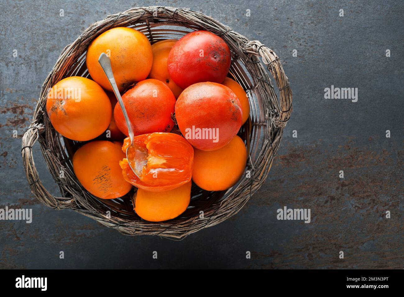 Ripe red and yellow orange persimmon fruit.Slices of persimmon. Close ...