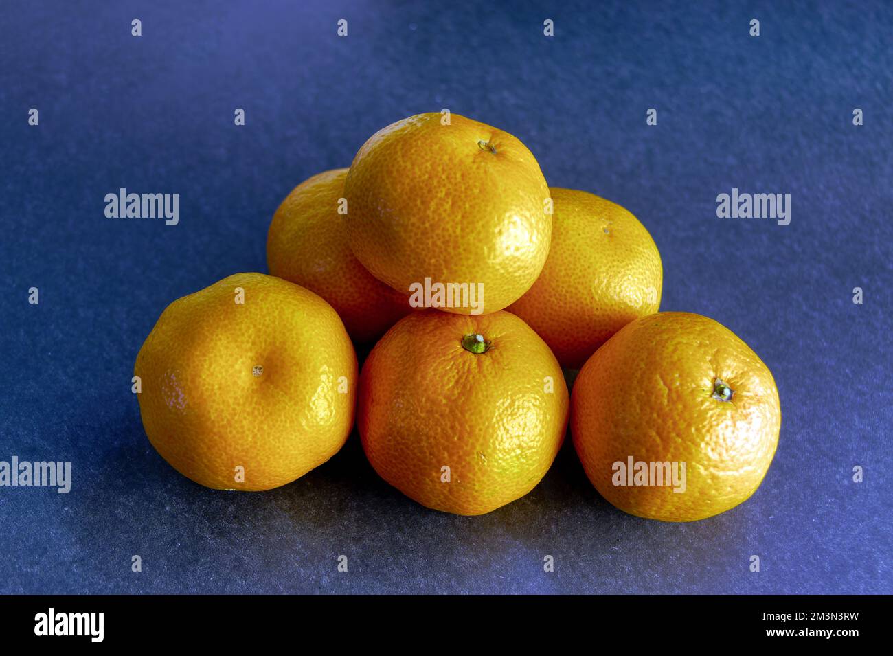 Ripe orange tangerines on a dark gray background Stock Photo - Alamy