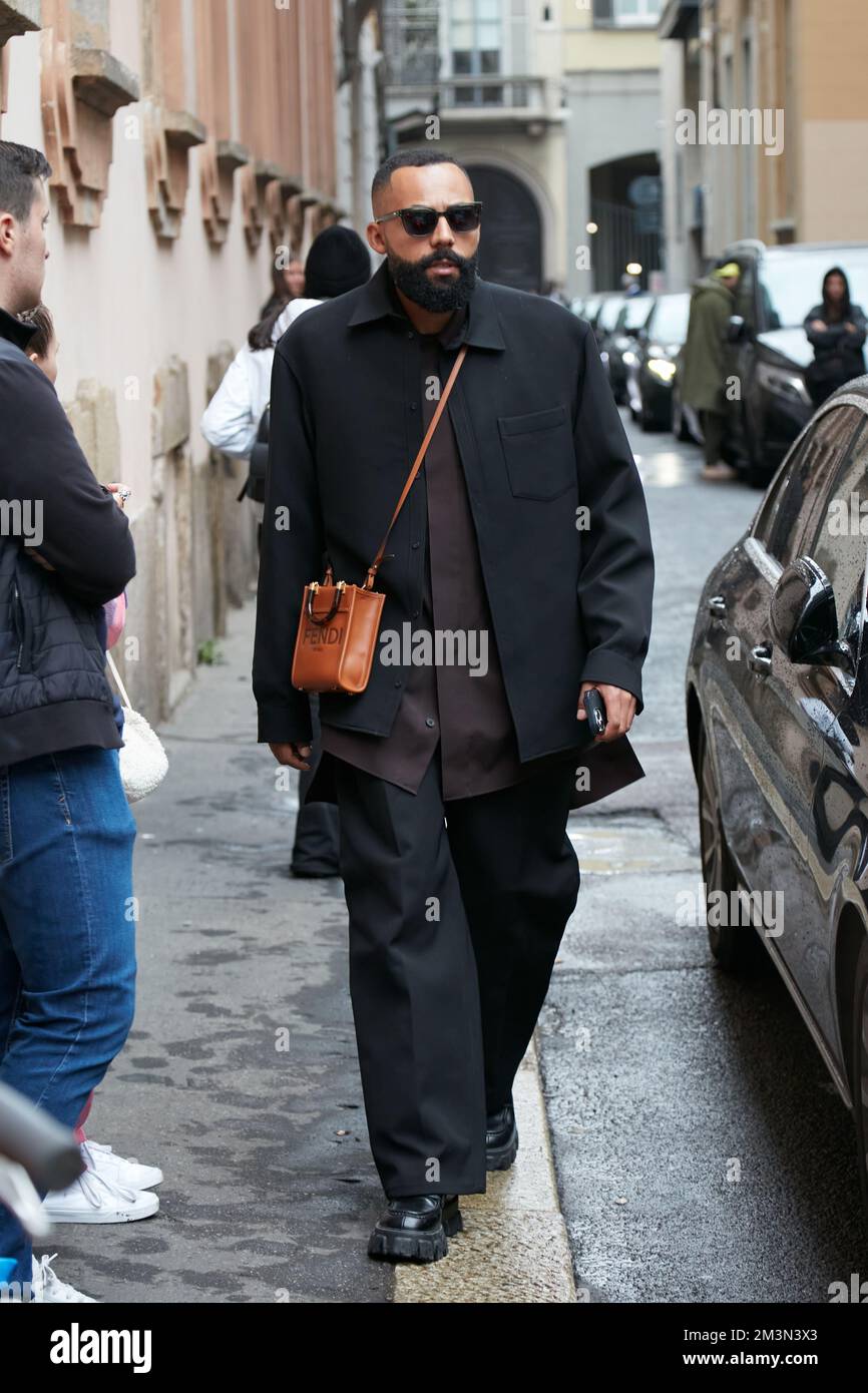 MILAN, ITALY - SEPTEMBER 24, 2022: Man with black jacket, trousers and ...