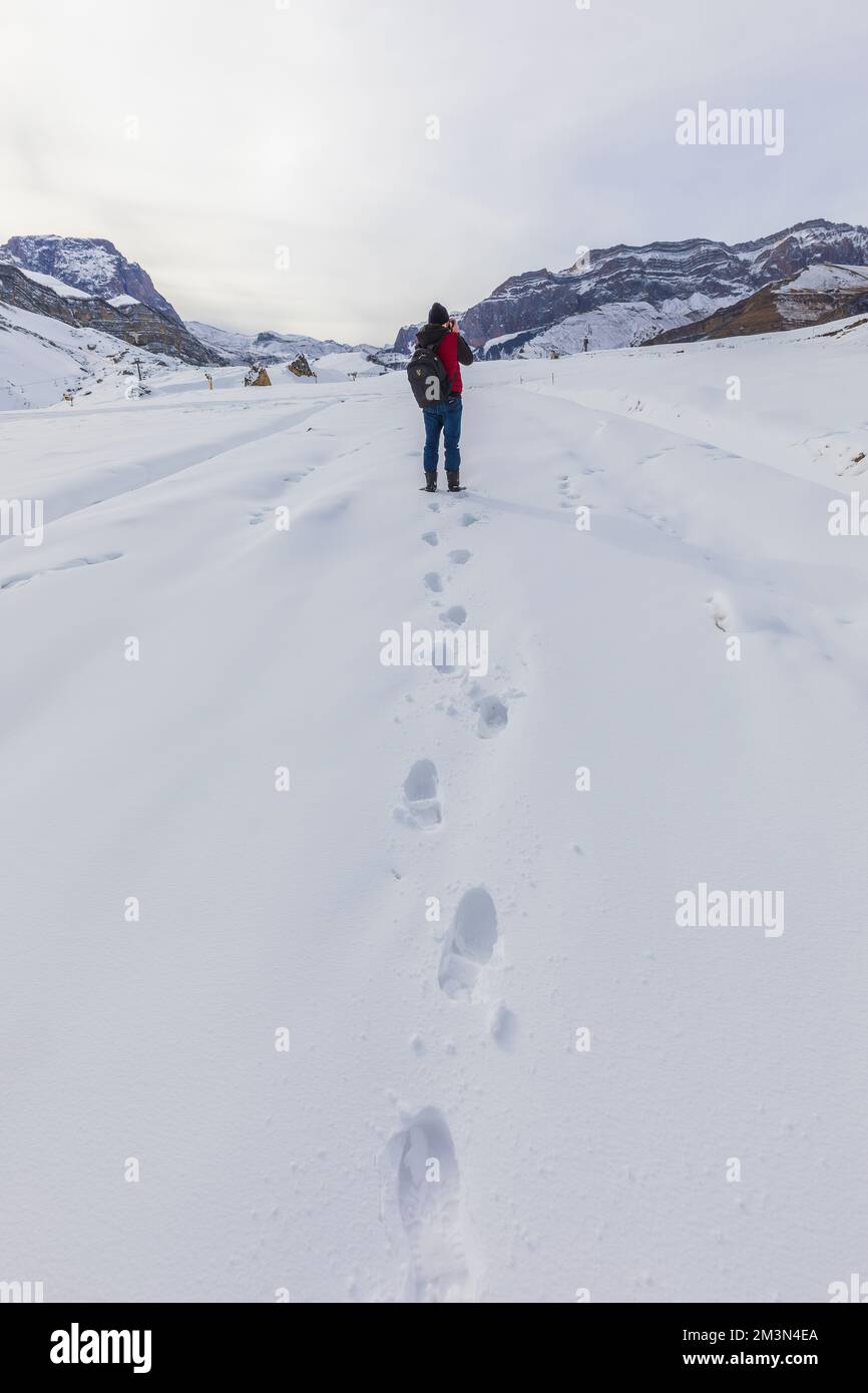 Tourist climbs the snow-capped peak of the snow-capped mountainsTourist ...