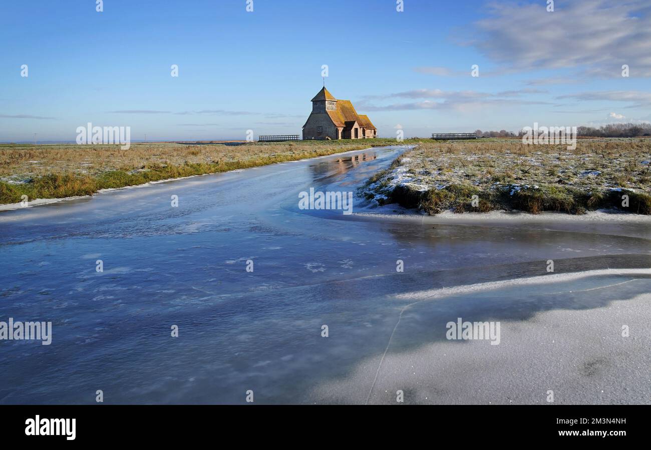 Frozen dykes surround the St Thomas Becket church on Romney Marsh in ...