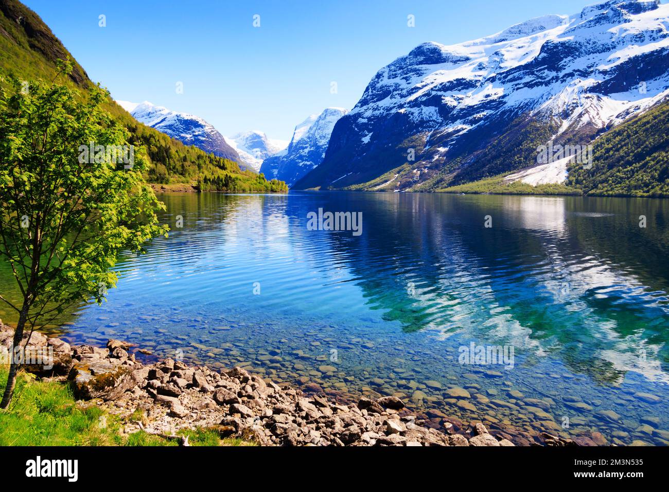 Mountain lake view, Lake Lovatnet. Clear water from glacial meltwater ...
