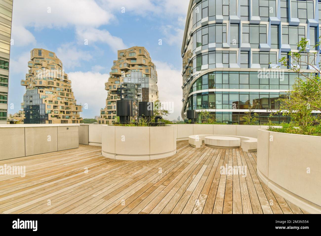 an outdoor area with wooden flooring and modern buildings in the photo ...