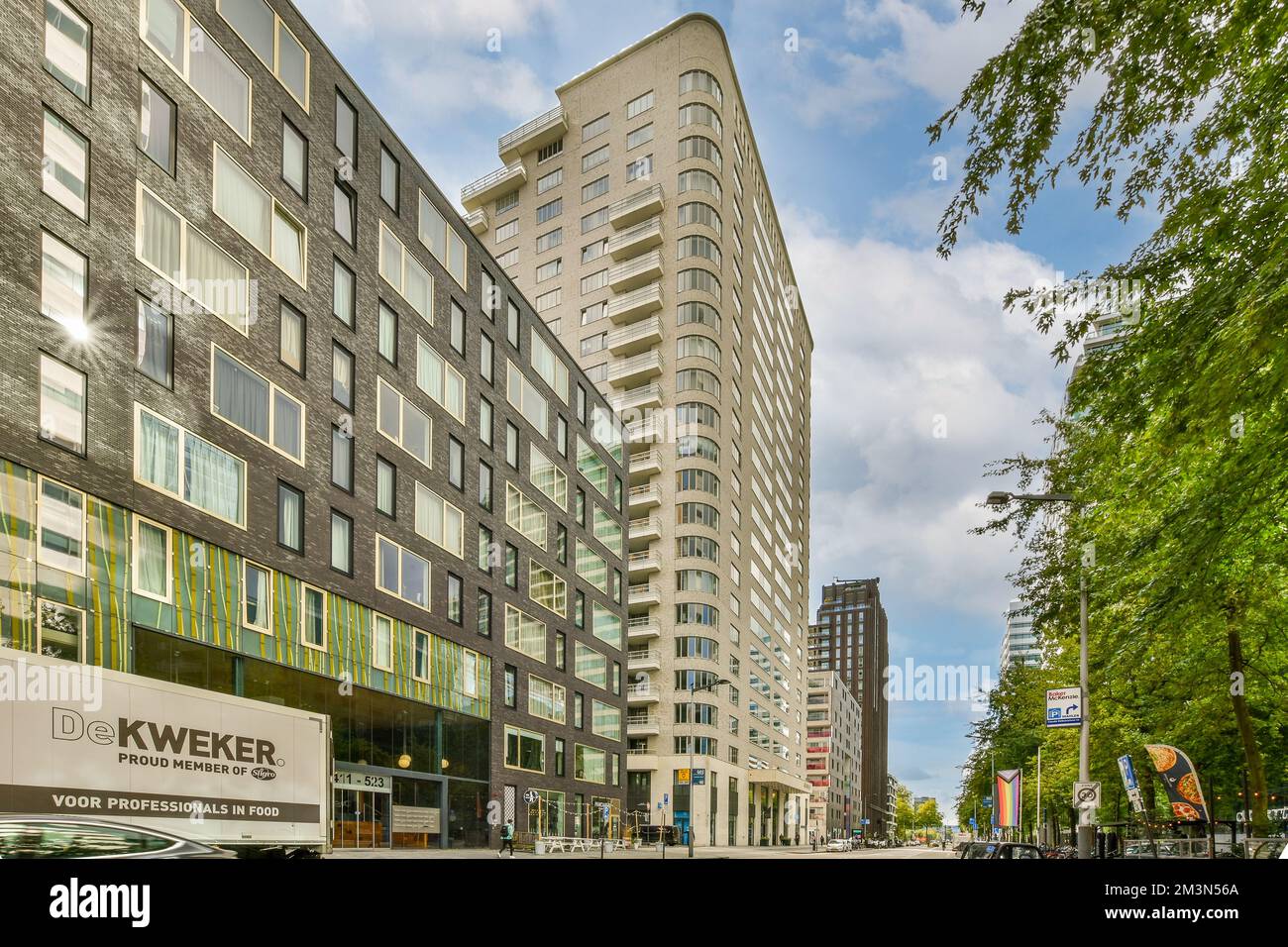 a city street with cars parked on the side of the road in front of an ...