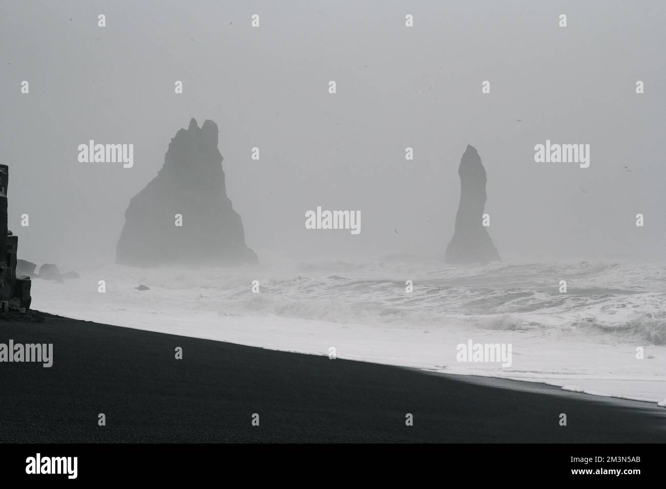 Steep cliffs on beach monochrome landscape photo Stock Photo - Alamy