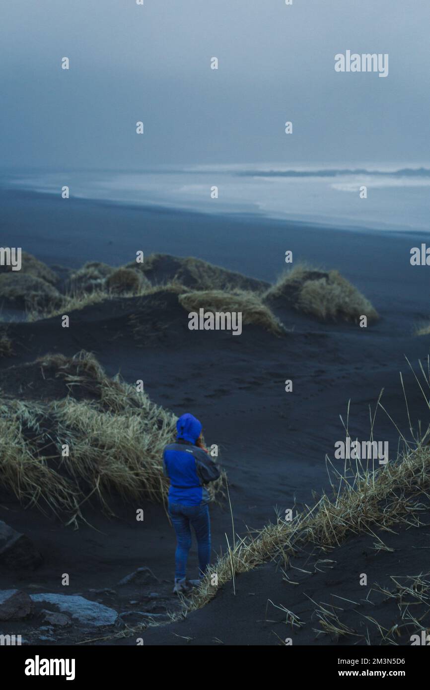 Woman on Reynisfjara beach landscape photo Stock Photo - Alamy