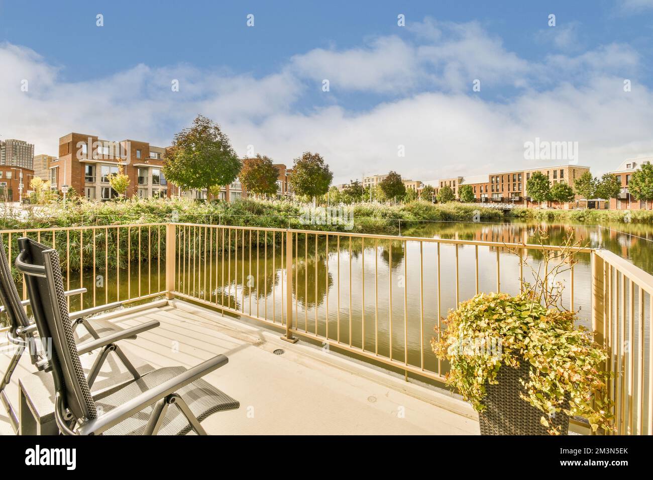 a balcony with chairs overlooking the water and buildings on both sides ...