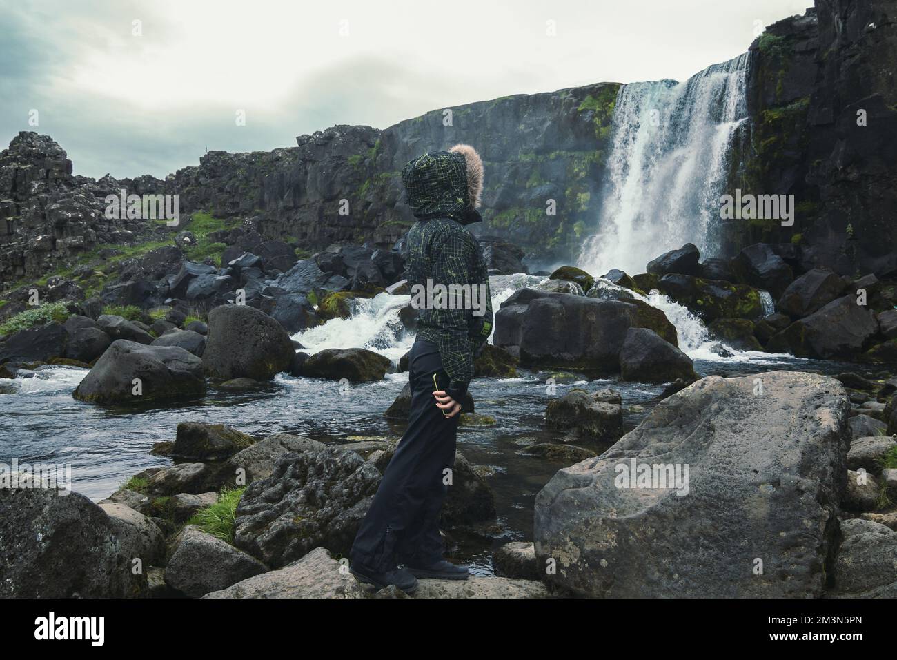 Woman looking at waterfall landscape photo Stock Photo - Alamy