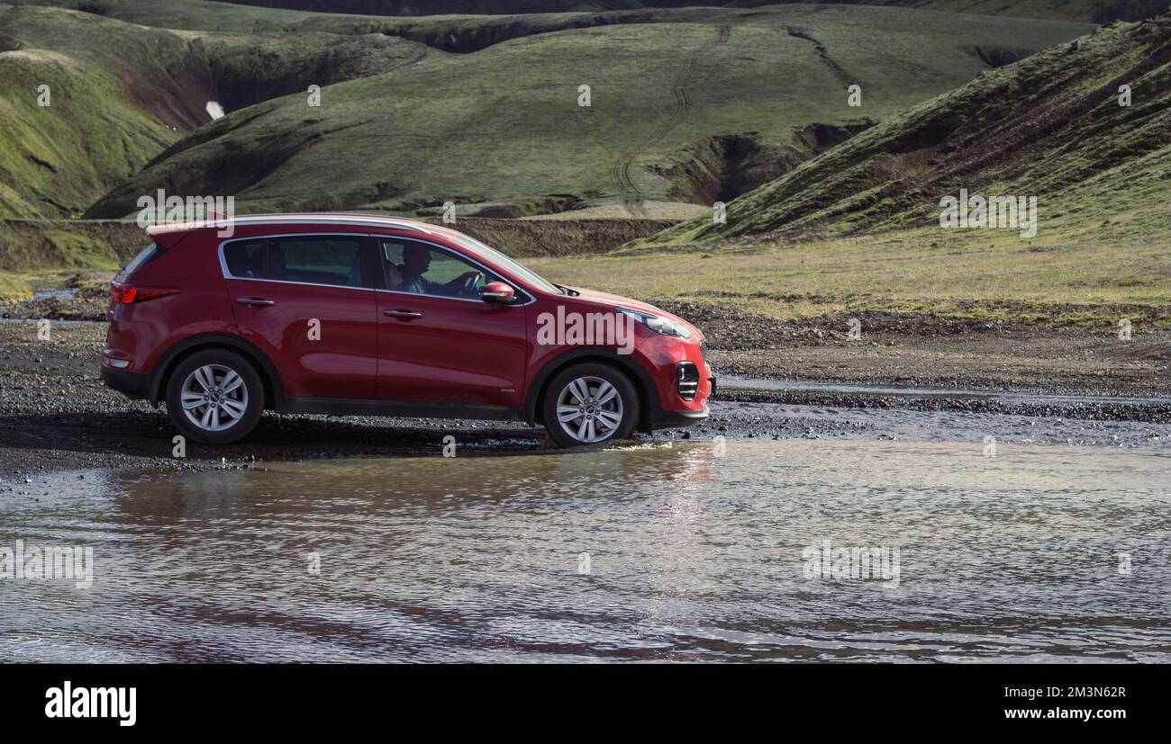 Tourists driving car across river landscape photo Stock Photo - Alamy