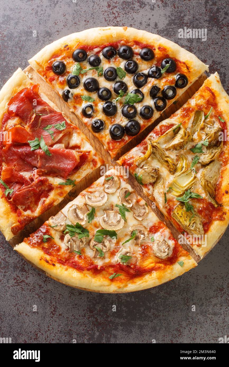 Pizza fresh out of the oven four seasons with tomatoes, mozzarella ...