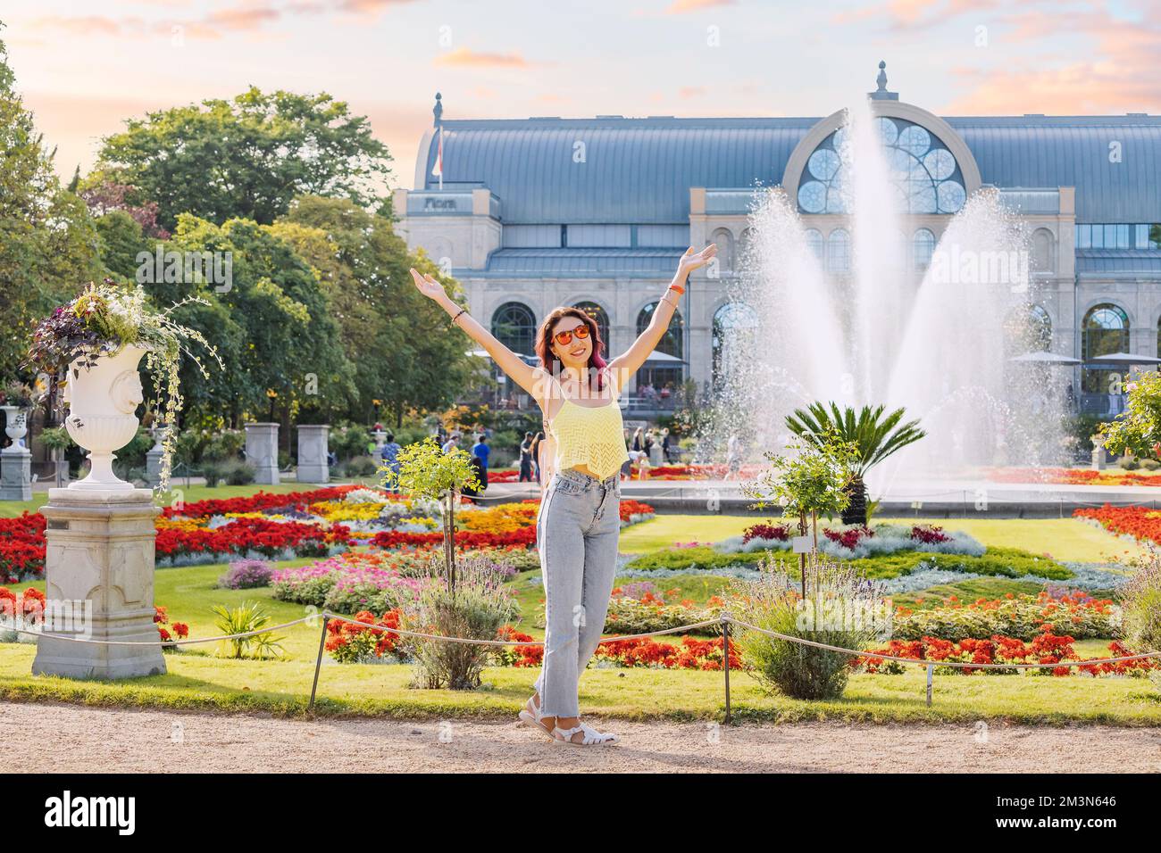 Happy tourist girl walks and enjoys holiday in the Botanical Flora ...