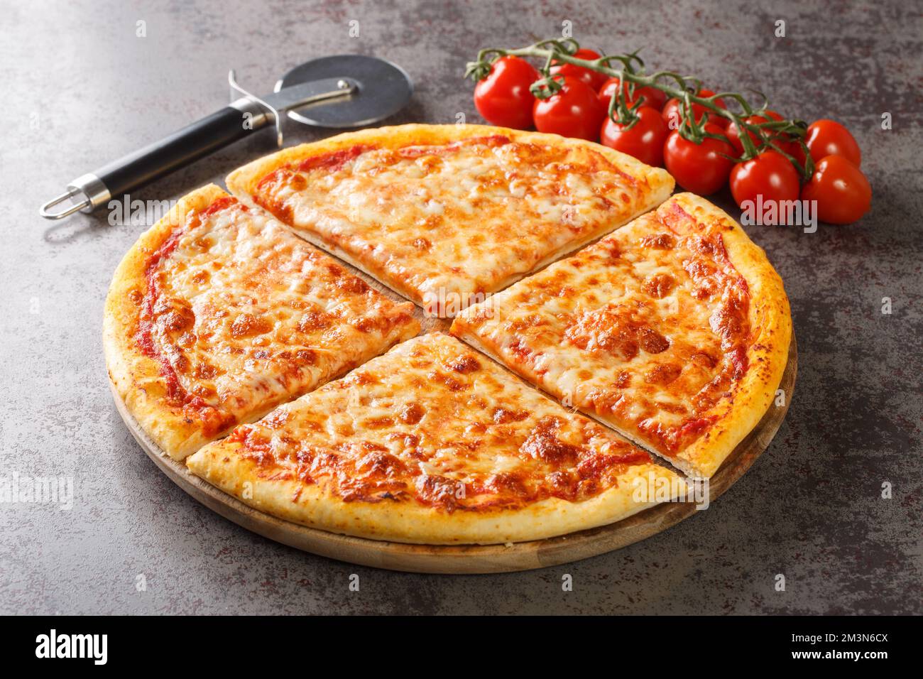 Homemade Greasy New York Cheese Pizza Ready to Eat closeup on the board ...