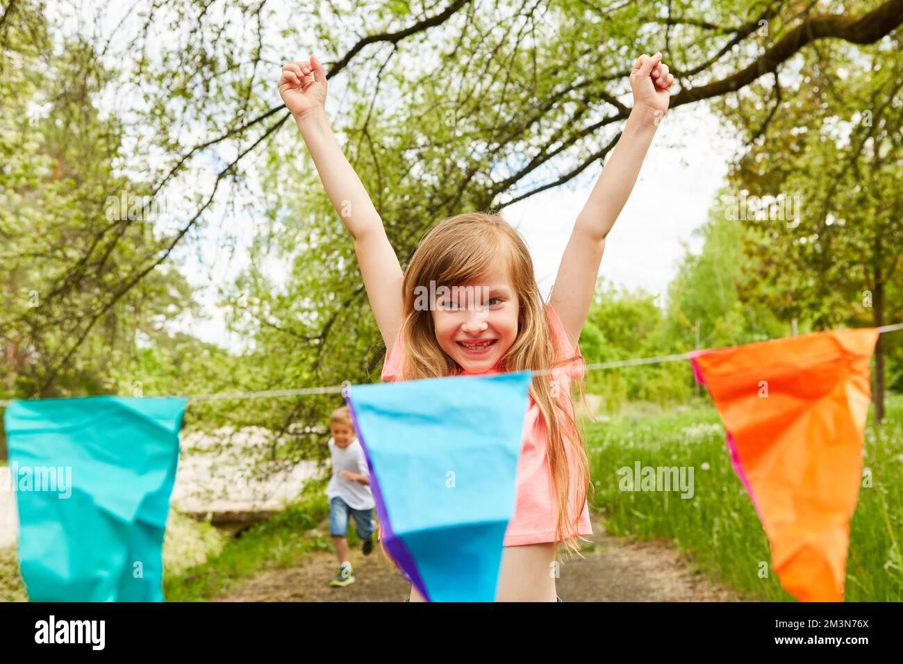 Happy girl reaching finish line and winning race competition in park ...