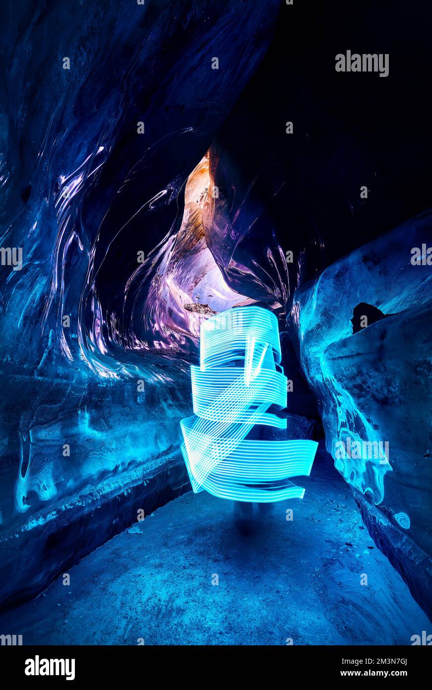 Landscape of amazing glacial ice cave with blue led lights beam inside ...