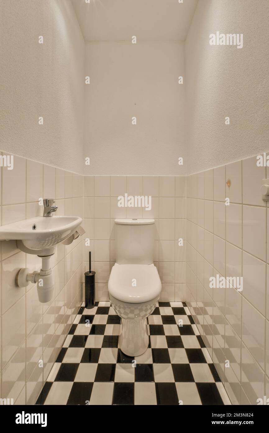 Flush toilet and shower cabin with tile partition and curtain located ...