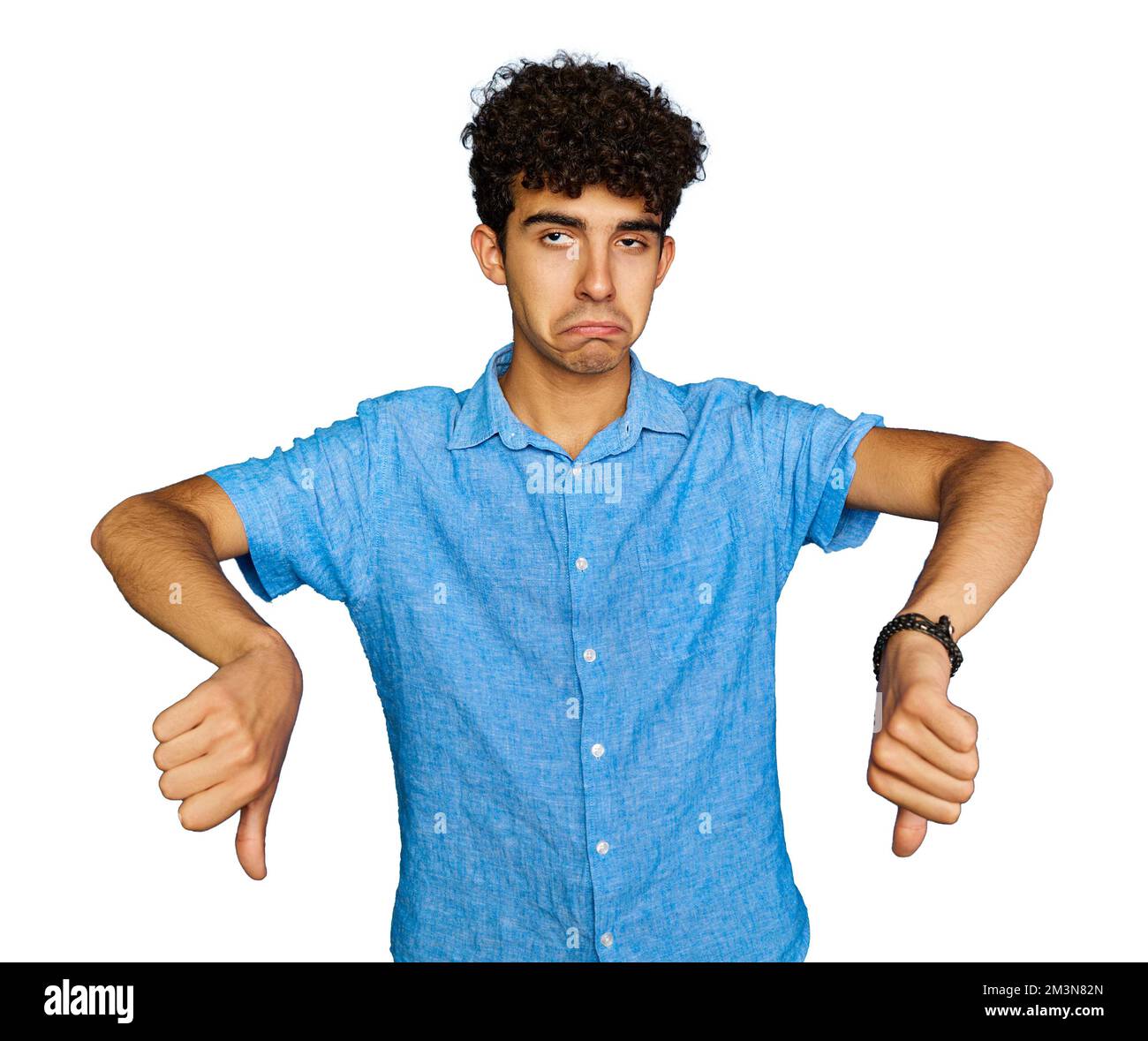 Upset teenage boy with casual clothes and wavy black hair sad ...