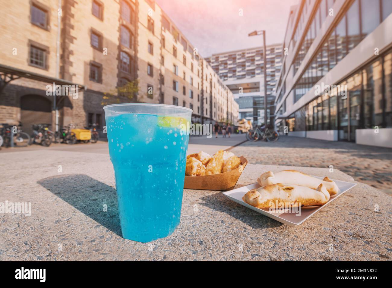 Unusual blue soda with lemon and street food meal. Snack and takeaway ...