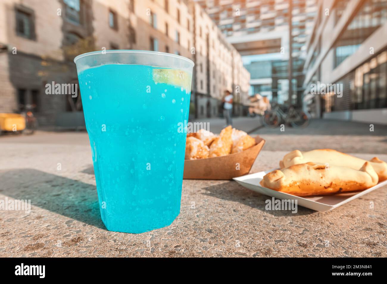 Unusual blue soda with lemon and street food meal. Snack and takeaway ...