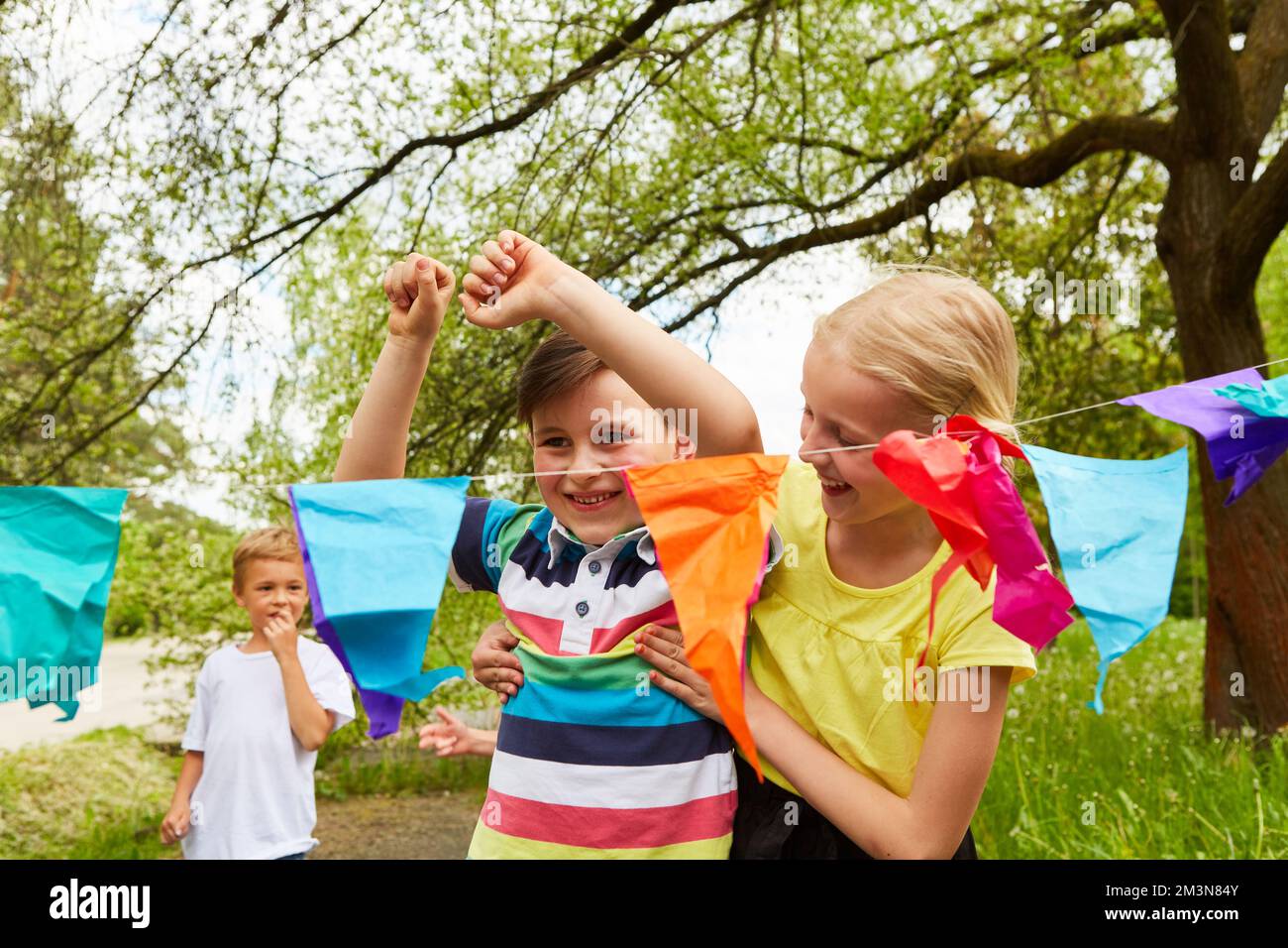 Happy girl looking at male friend reaching finish line and winning race ...