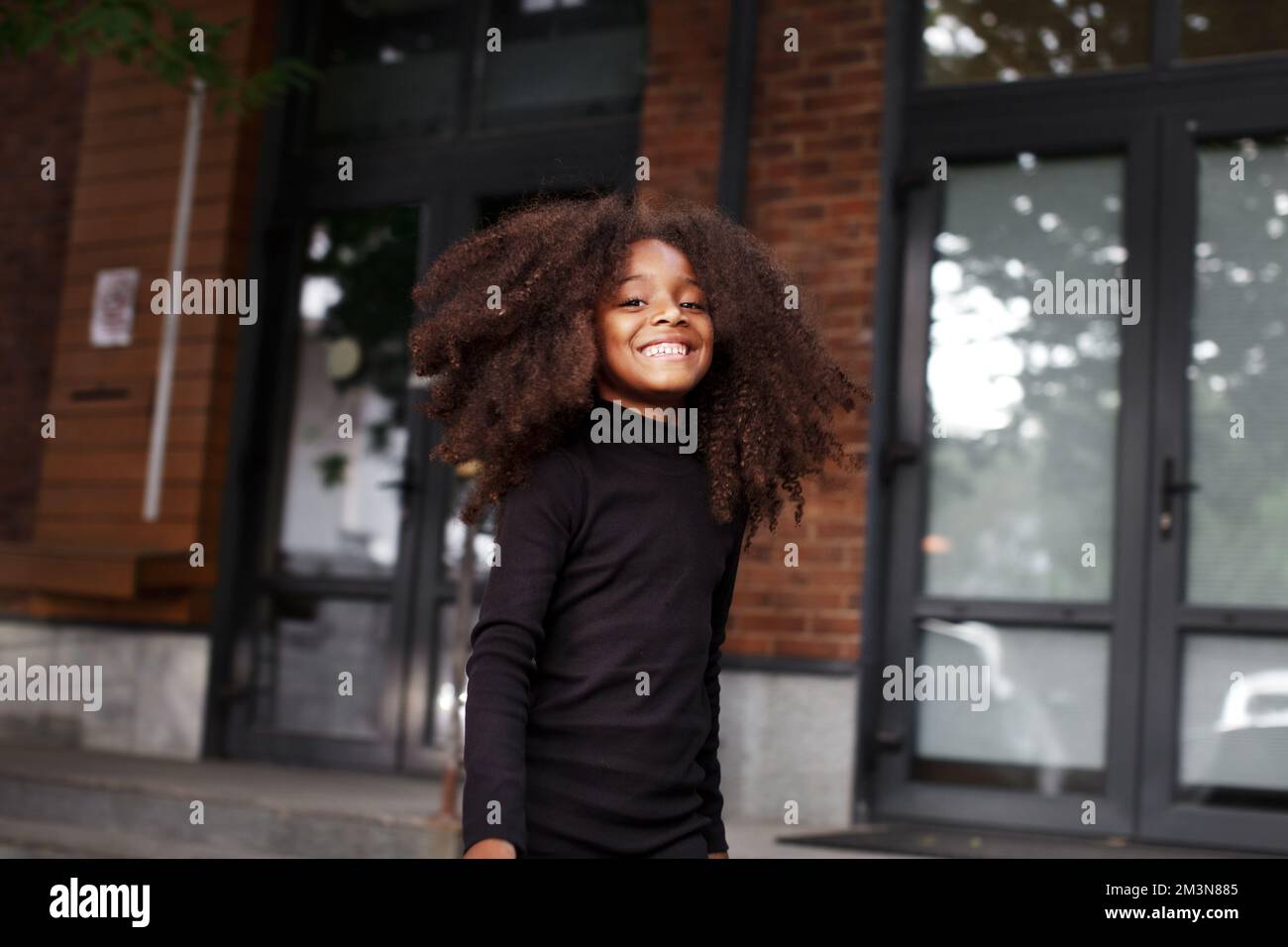 Authentic portrait African American child girl smiling and looking ...