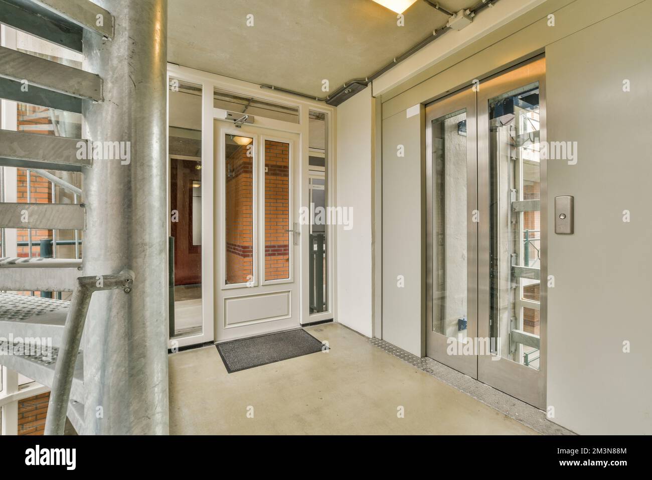 The front view of a building with wooden doors lead to the apartment ...