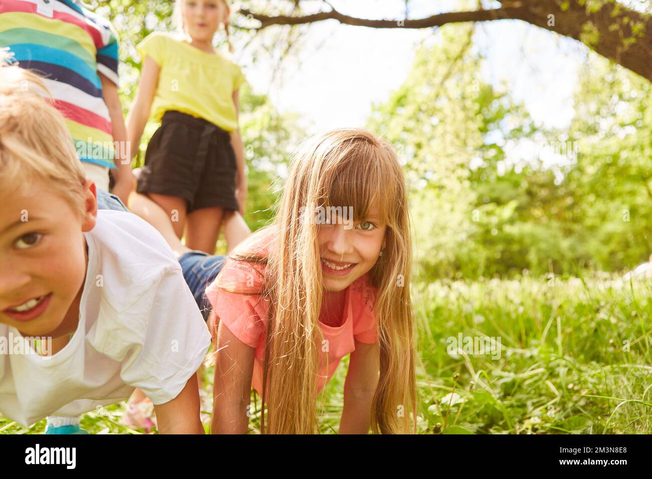 Portrait of smiling male and female friends competing each other during ...
