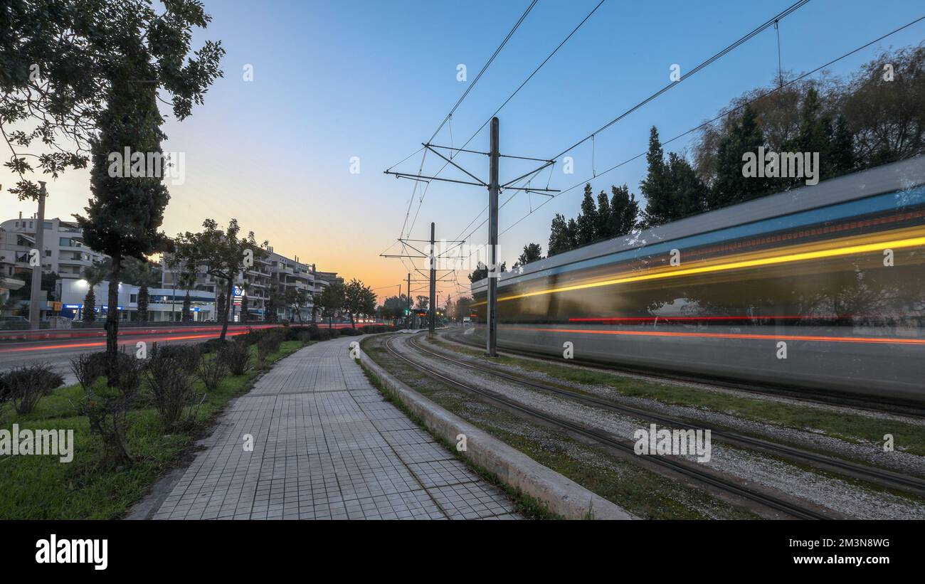 A long exposure of train light trails on sunset sky background seen ...
