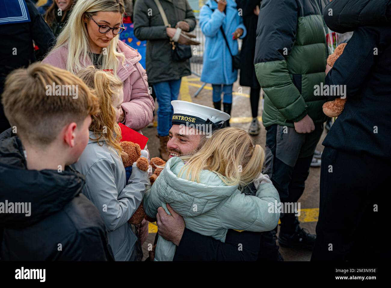 A sailor gets hugs as families and loved ones greet the return of HMS ...
