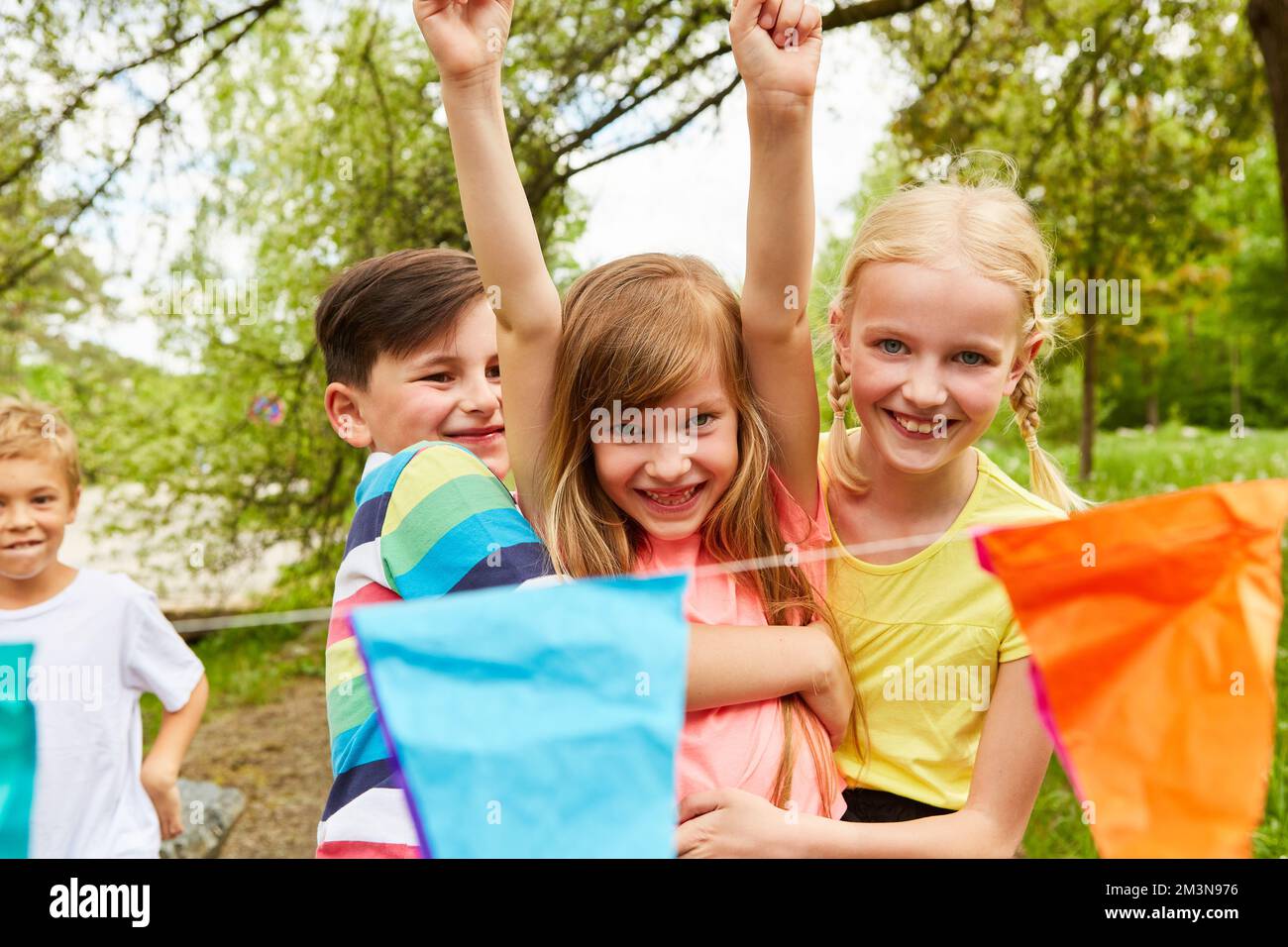 Happy group of children celebrating winner after running competition ...