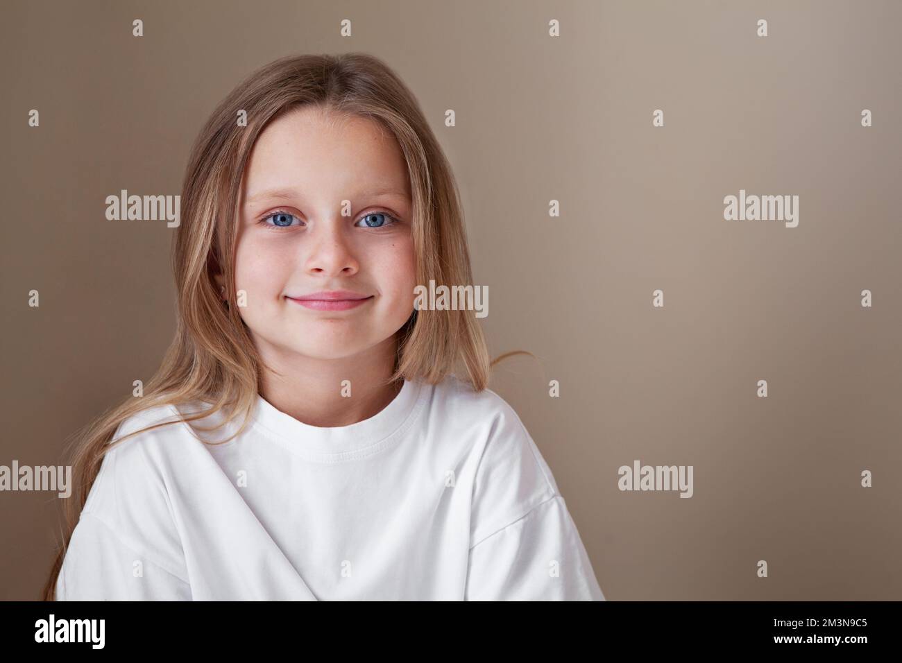 Pretty little girl blue eyes and long blonde hair wears white shirt ...