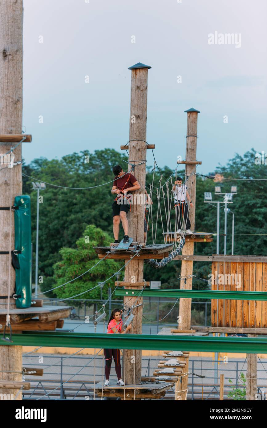 Adventure people climbing at the adventure park at different levels ...