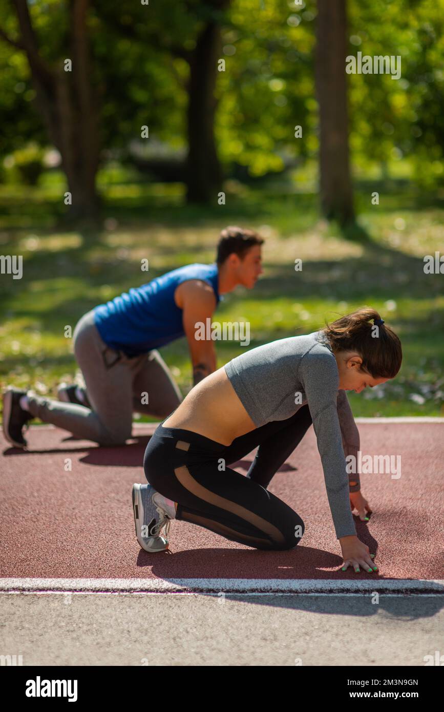 Two young friends getting into the starting positions for thier run at ...